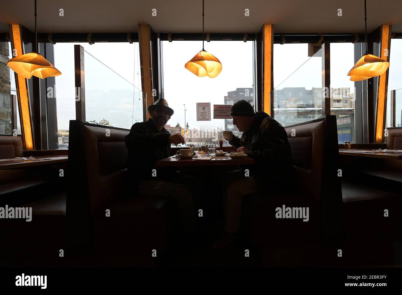 Mitch Blank (l) and Vincent Bracco (r) sit at a booth with glass ...