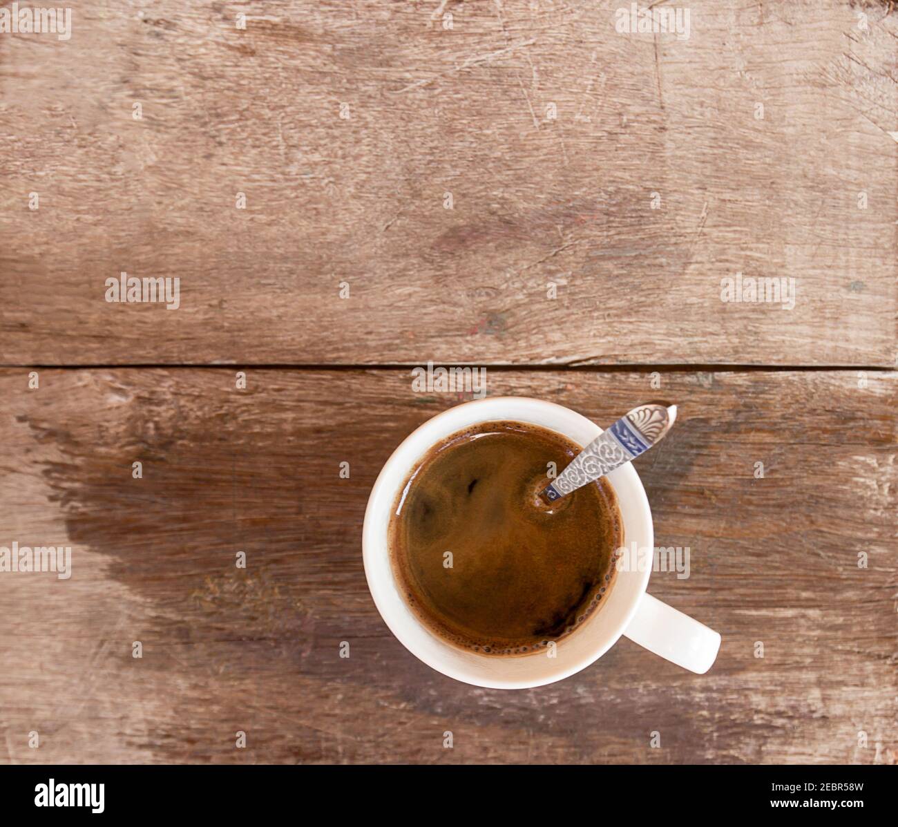 Cup of coffee on a wood table background. Top view with copy space ...