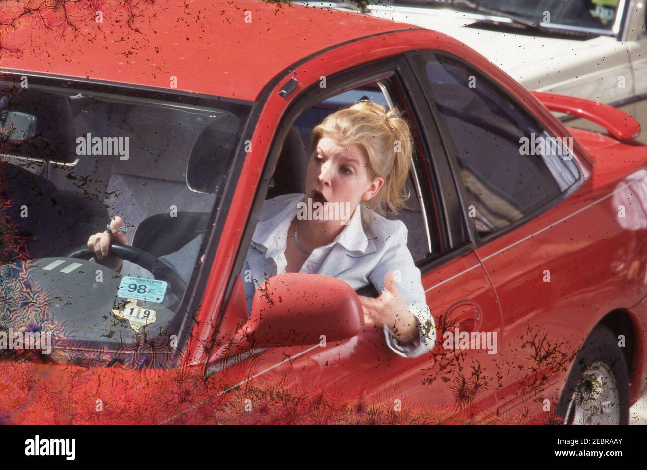 Road rage: Woman yells out her car window at another driver. Model ...