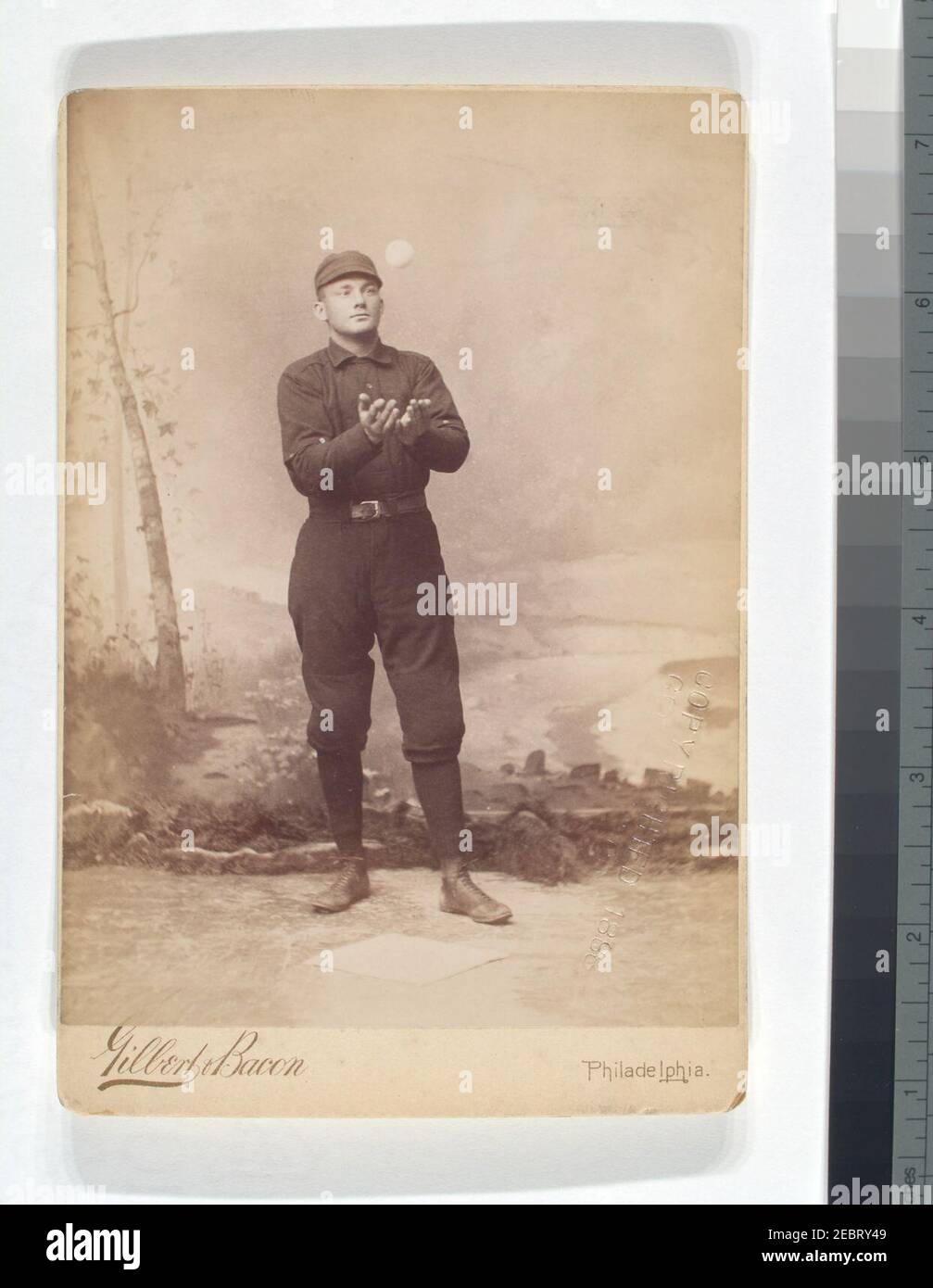 Unidentified baseball player in dark uniform - catching form Stock ...