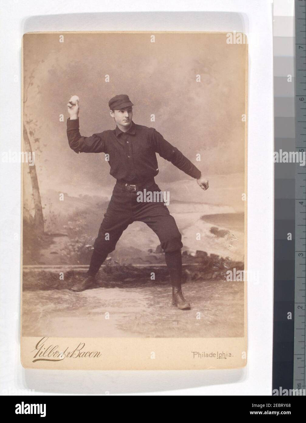 Unidentified baseball player in dark uniform - throwing form Stock ...