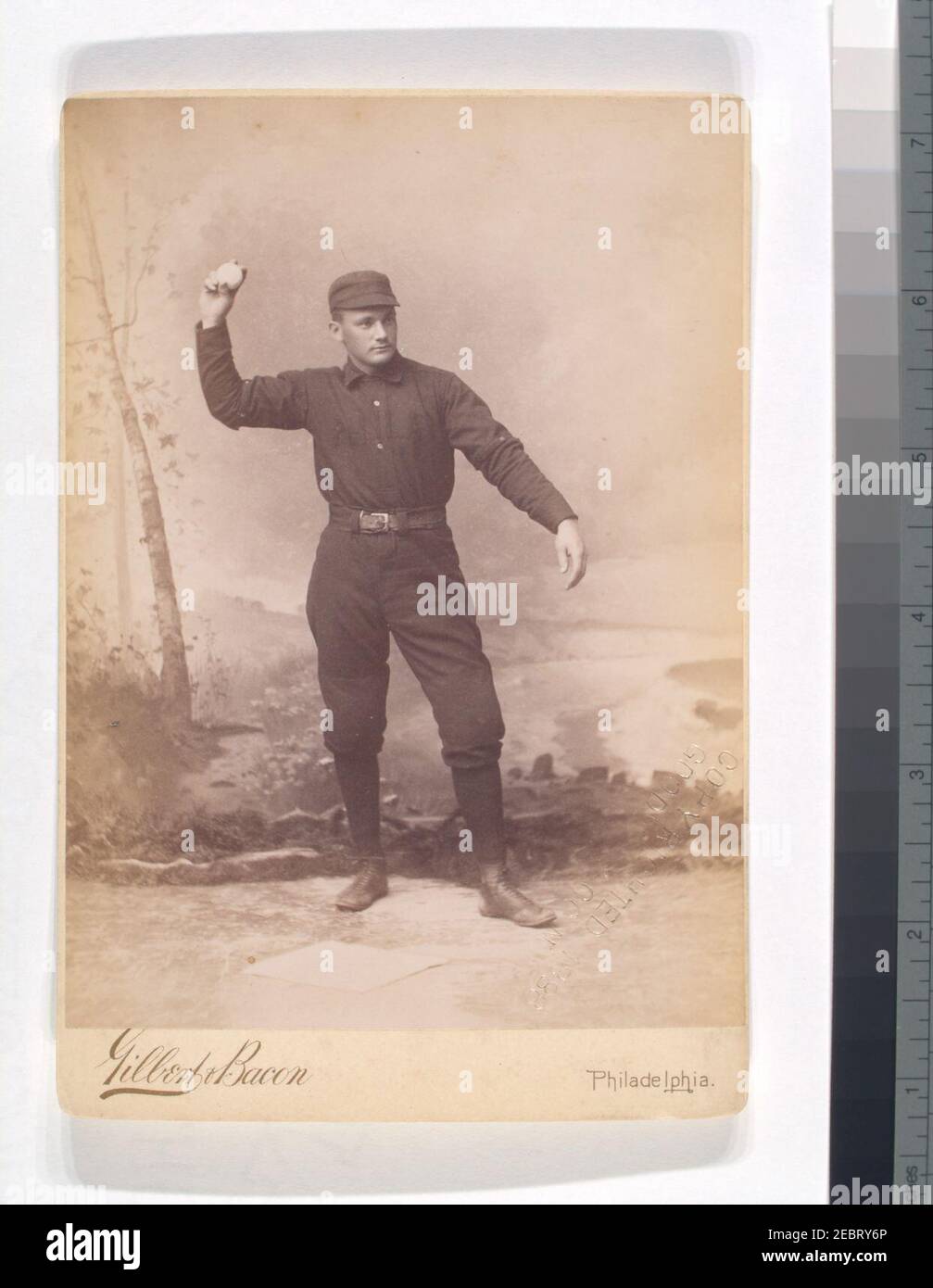 Unidentified baseball player in dark uniform - throwing form Stock ...