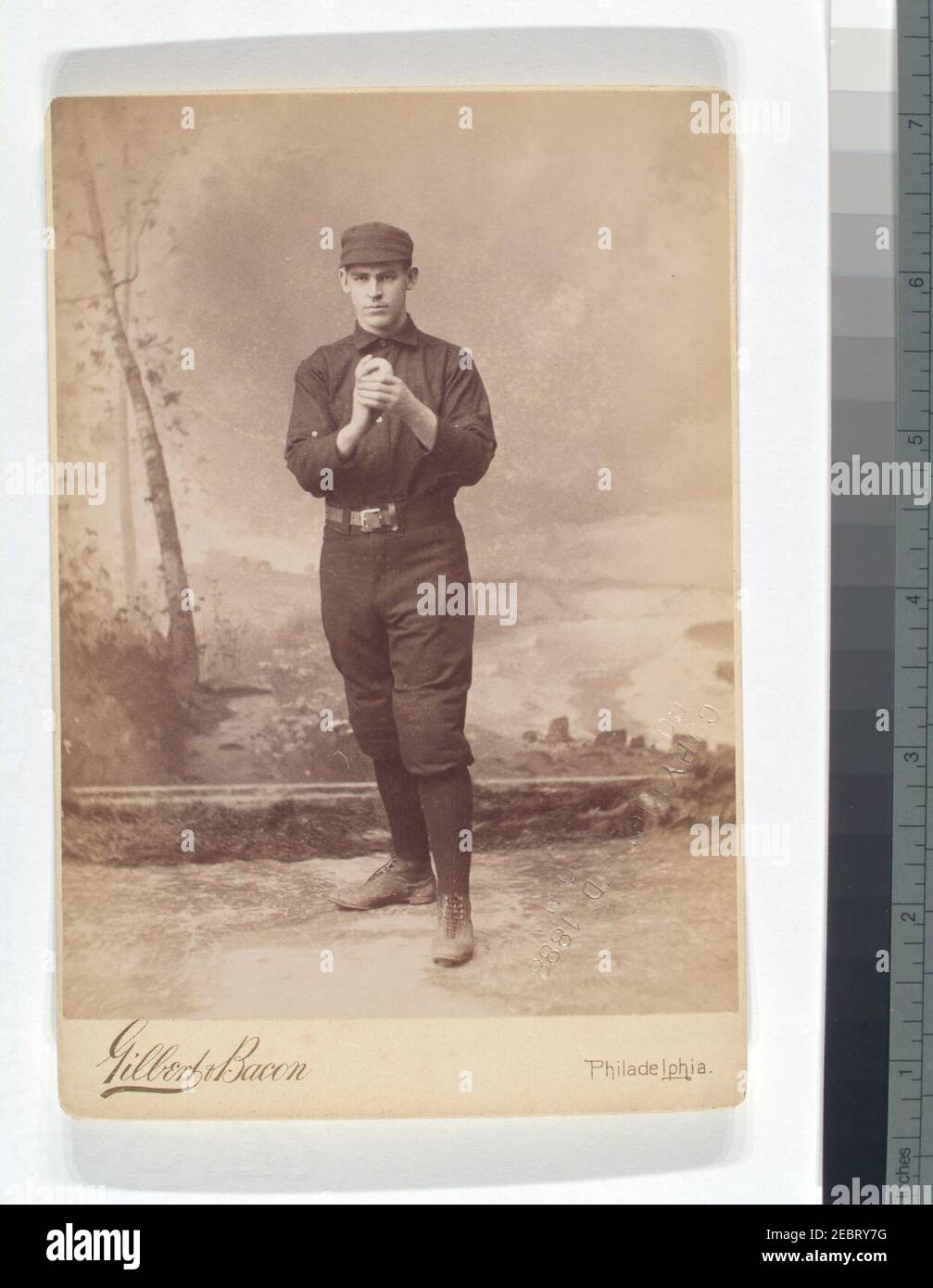 Unidentified baseball player in dark uniform - pitchiing form Stock ...