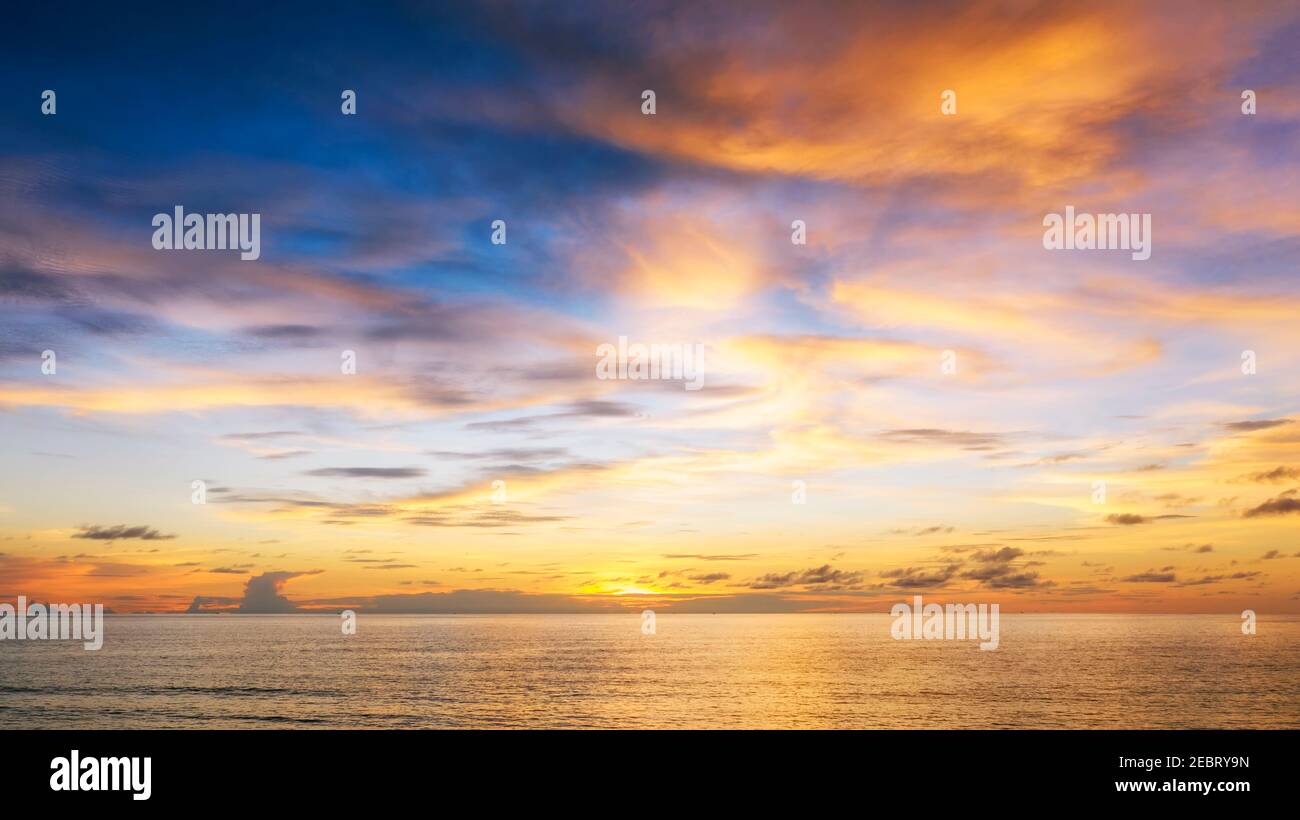 Beautiful sunset over the clam sea with cloud and sky background ...