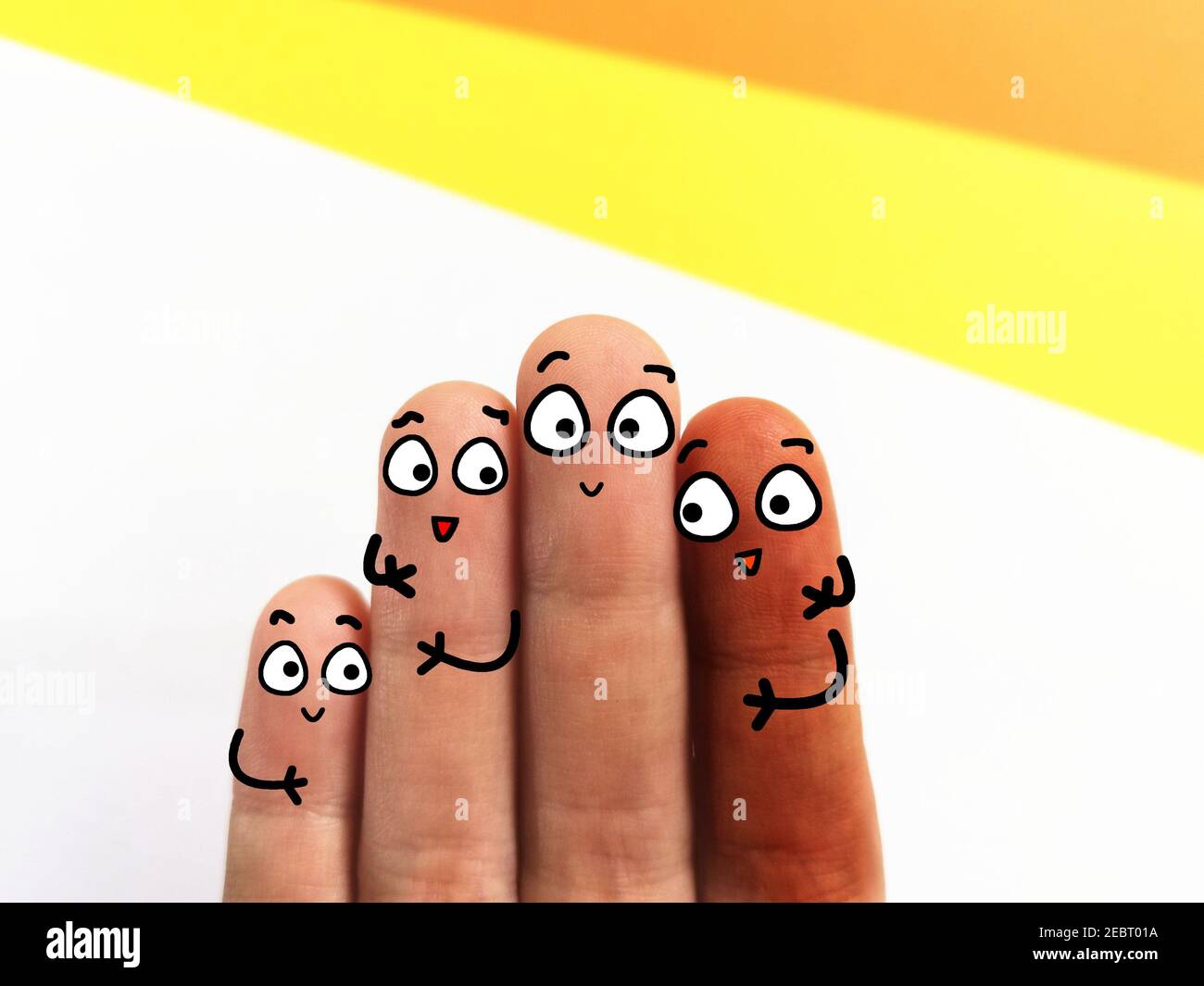 Four fingers are decorated as four person. They have different skin ...