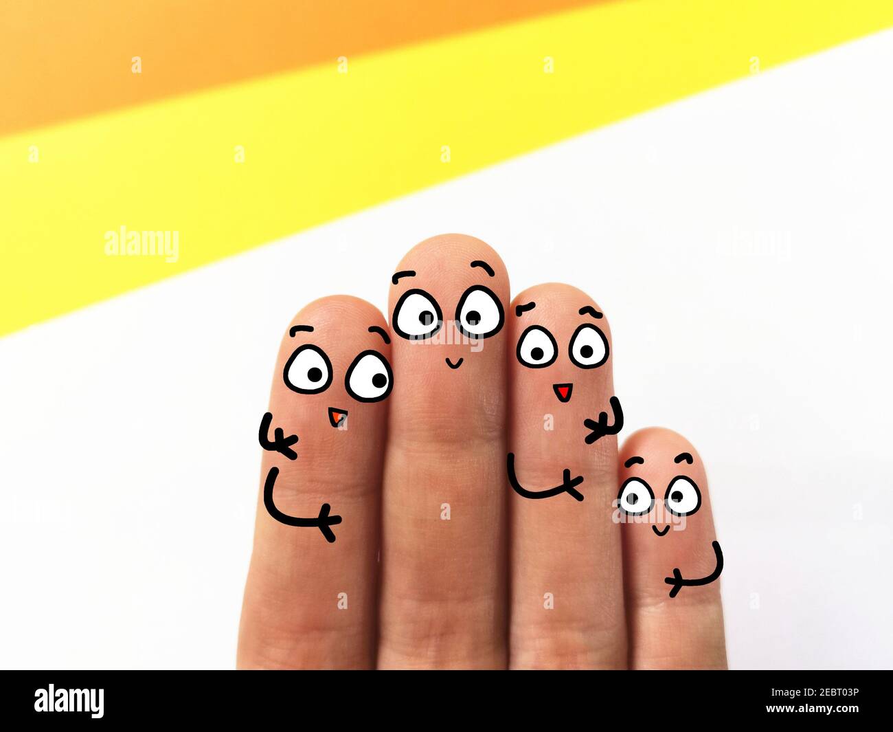 Four fingers are decorated as four person. They have different skin ...