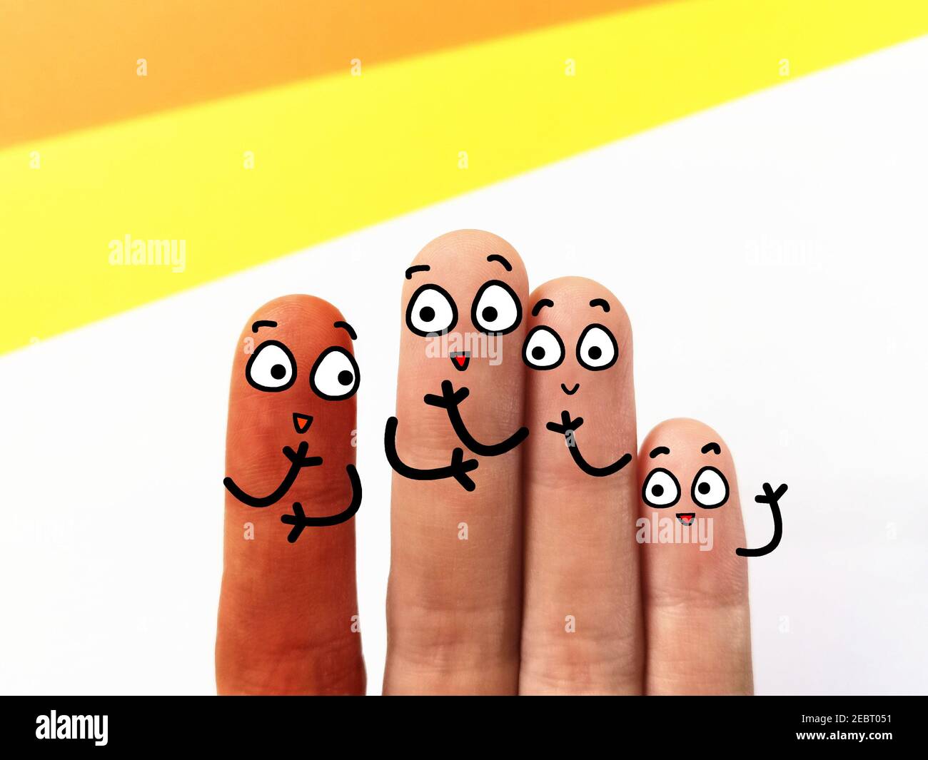 Four fingers are decorated as four person. They have different skin ...
