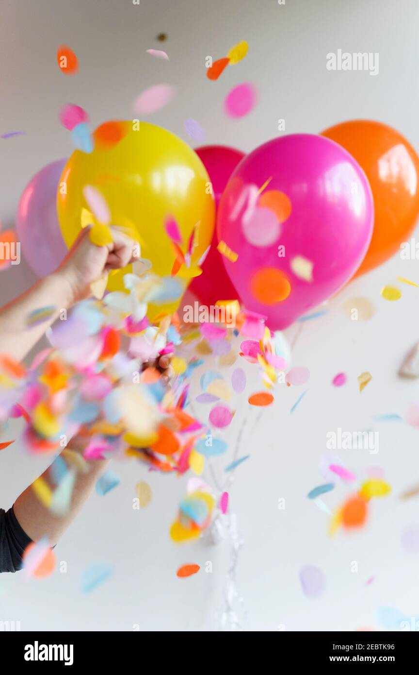 Hand holding bunch of colorful balloons Stock Photo - Alamy