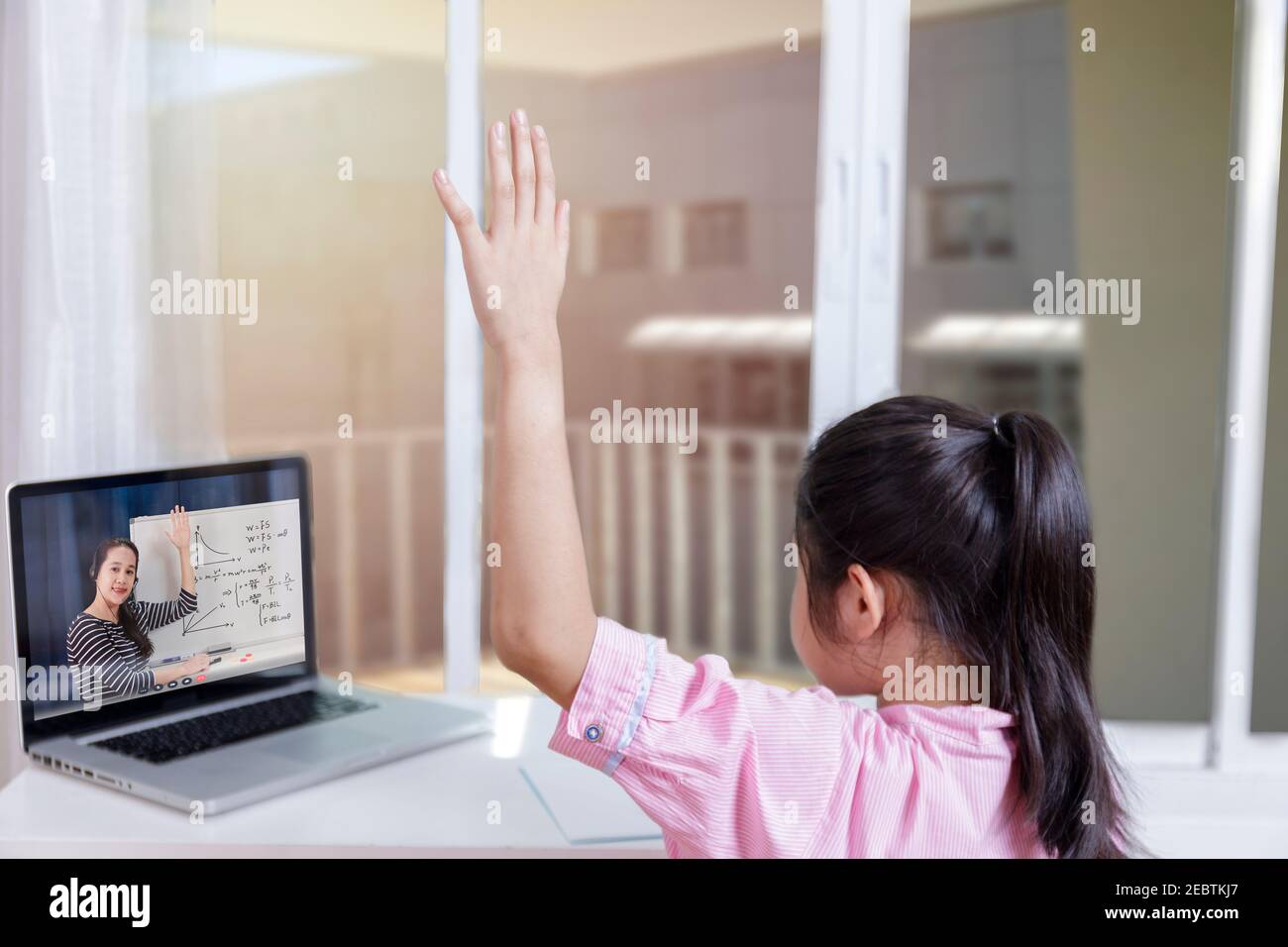 Asian little girl student learning via internet online class from ...
