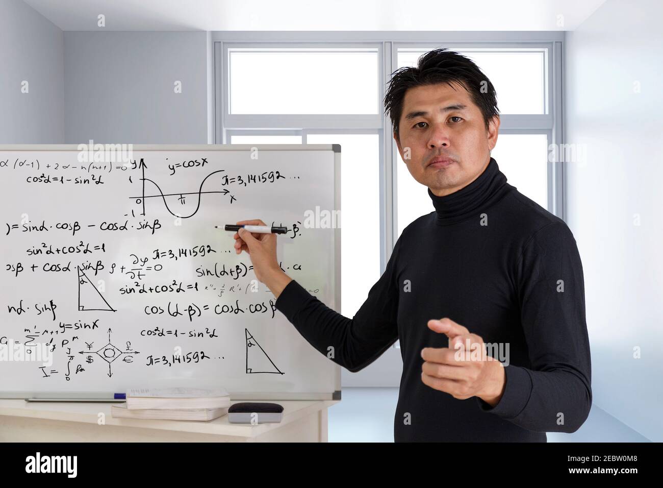 Mature professor teaching mathematics to students in classroom. Teacher ...