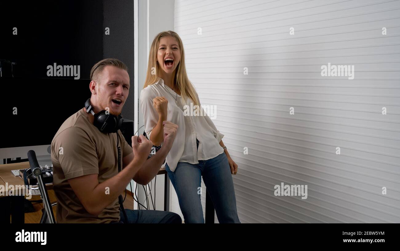 Sound engineer and singer showing signs of joy after finishing work ...