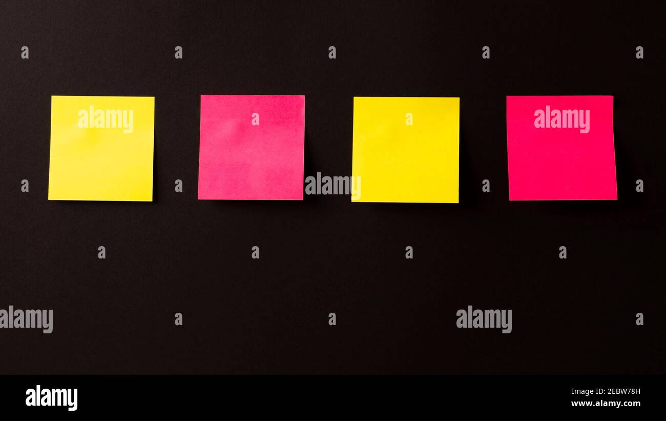 lots of colored stickers on a black background. stickers on the wall ...
