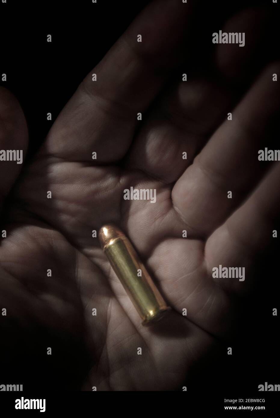 Hand holding bullet hi-res stock photography and images - Alamy