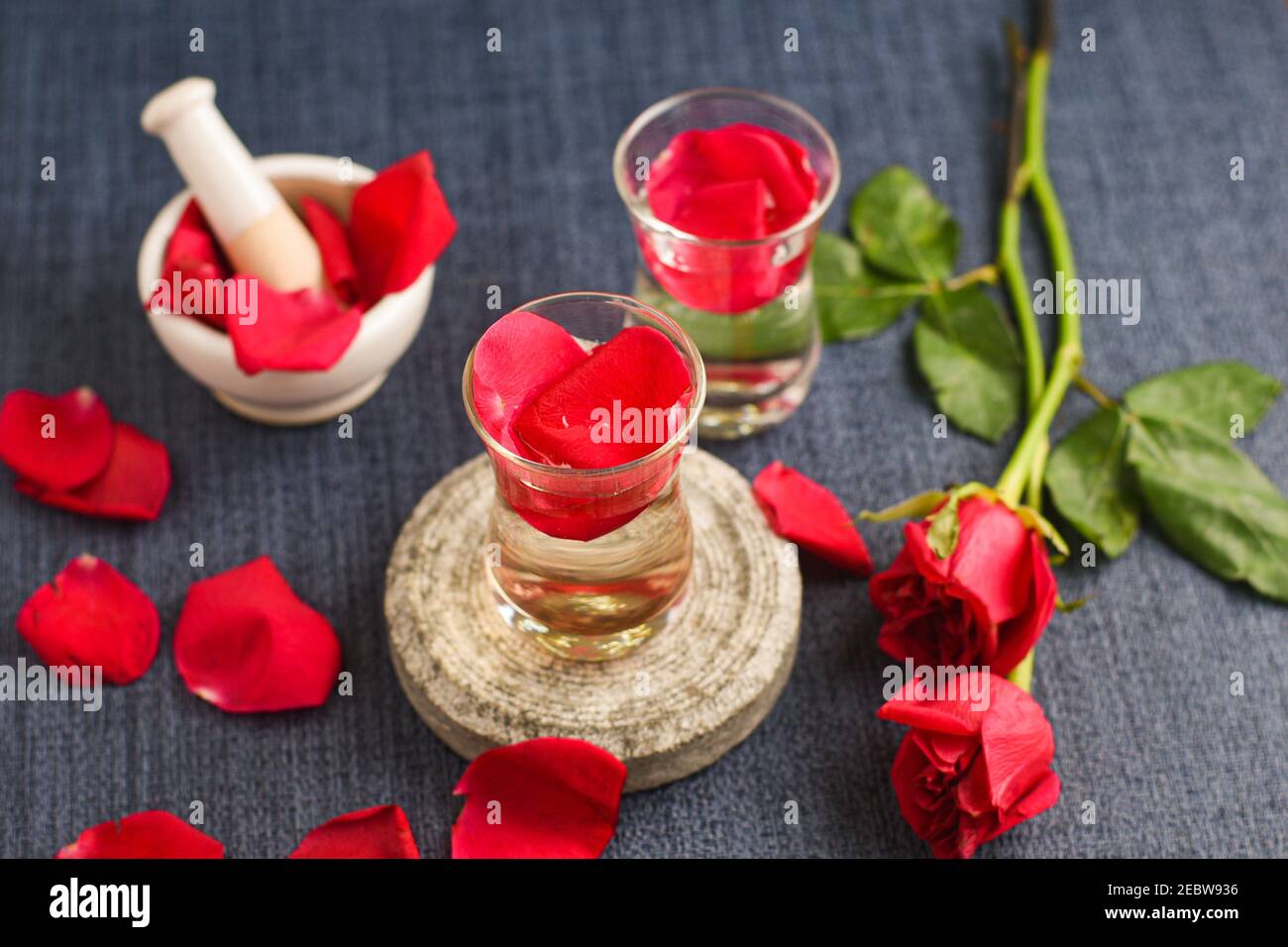 Rose water with rose petals Indian red rose flower. Making organic rose ...