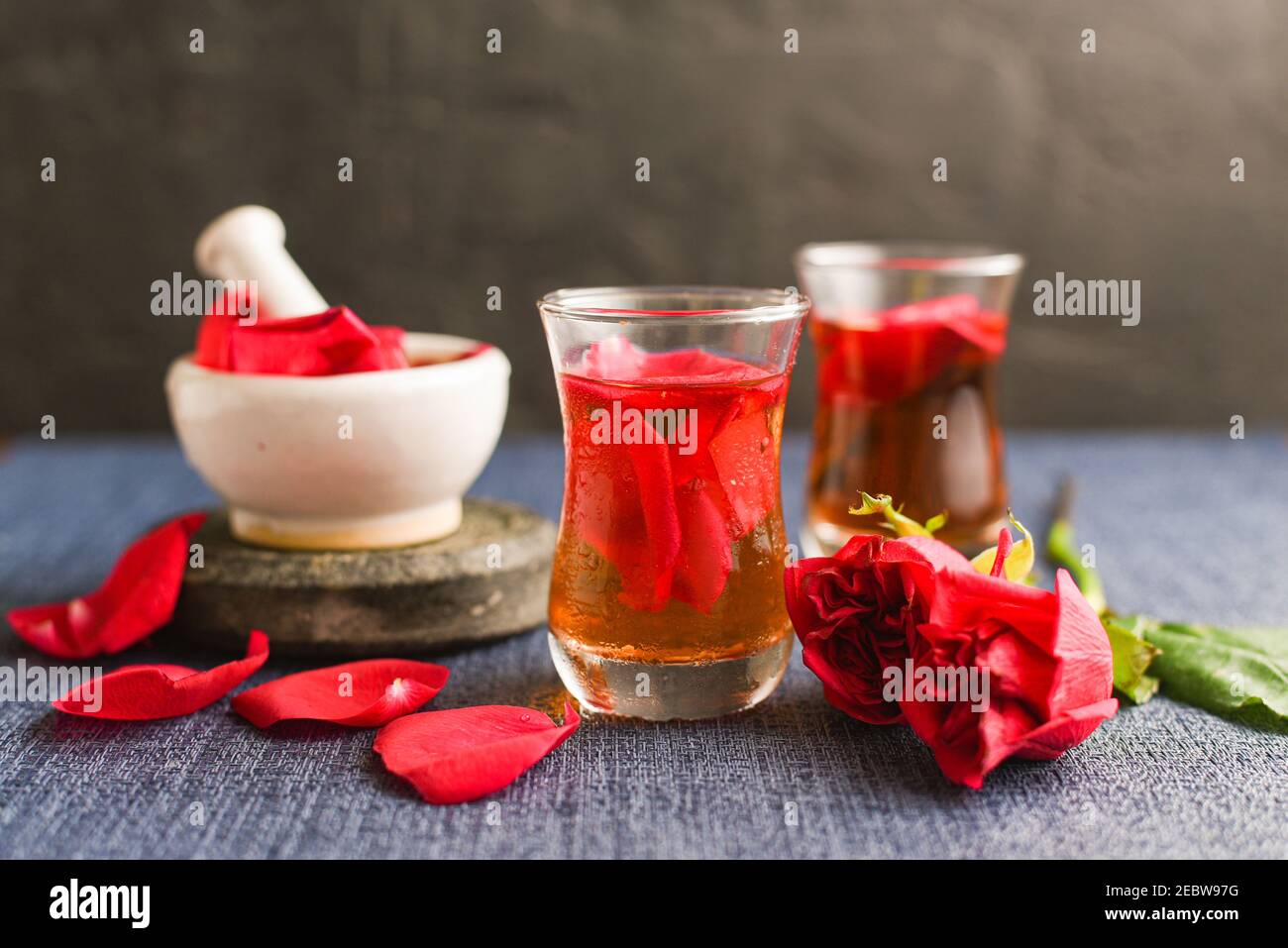 Rose water with rose petals Indian red rose flower. Making organic rose ...