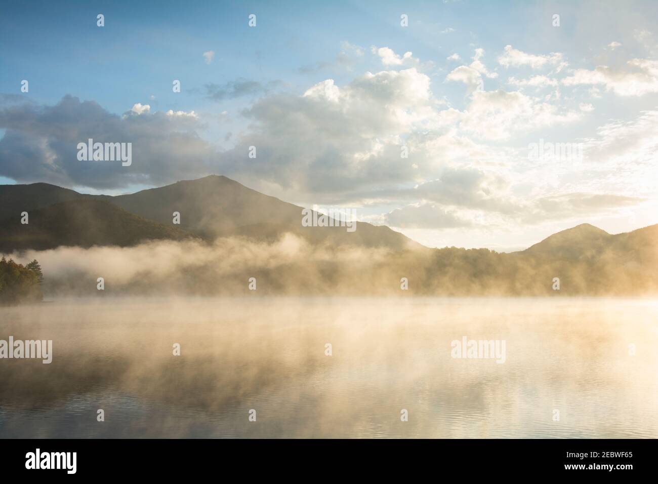 USA, New York, North Elba, Lake Placid, Morning mist rising on Lake ...