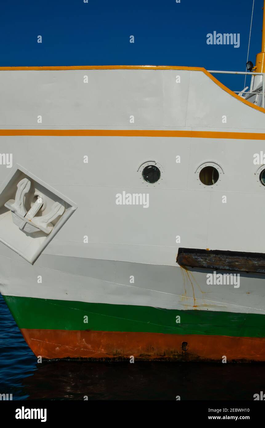 The bright colours of a ship’s hull against a dark blue sky Stock Photo ...