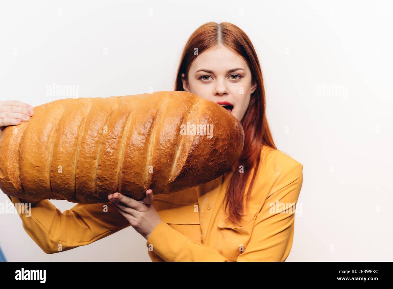 beautiful woman with a loaf of bread on a colored background fun ...