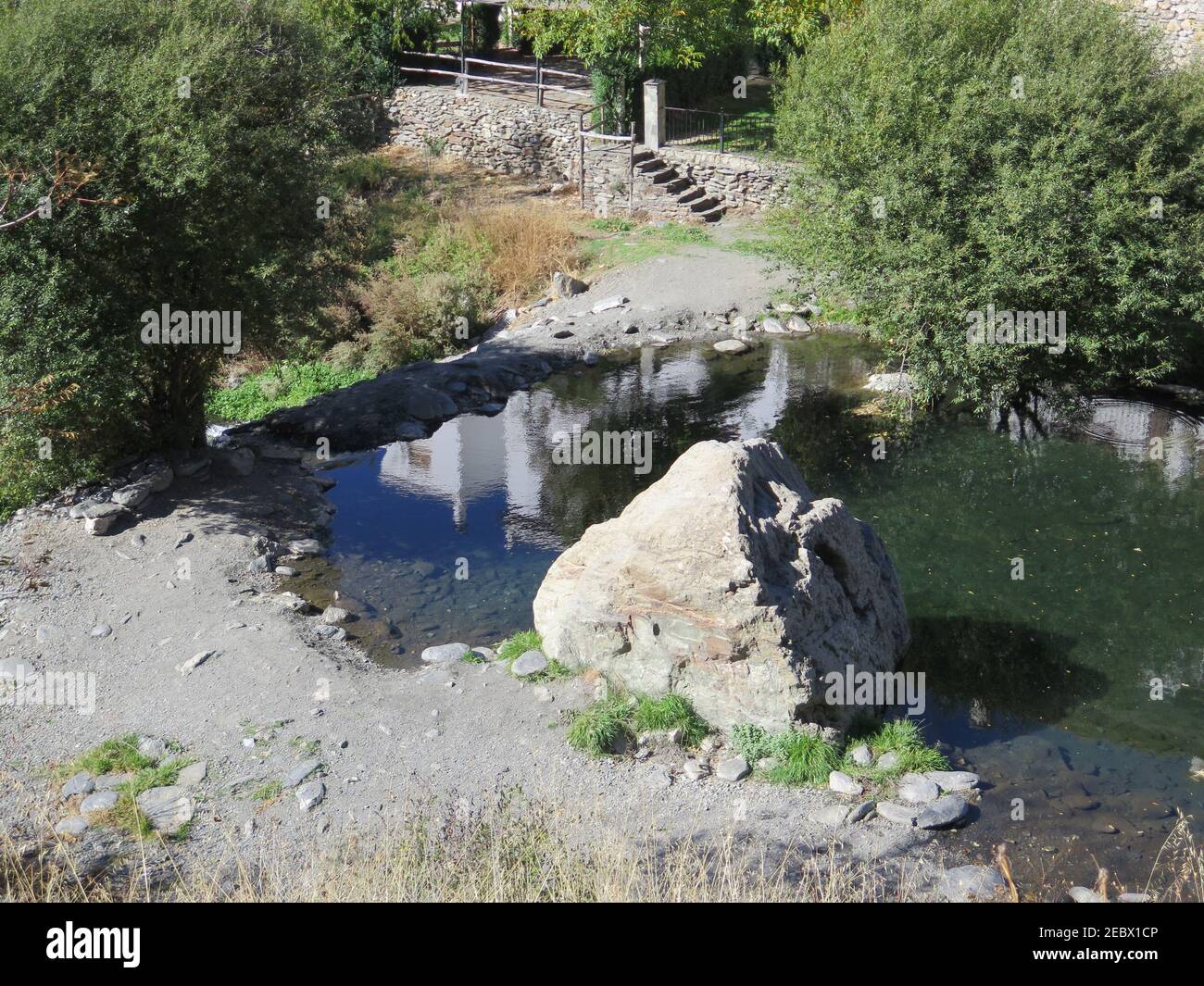 Sun shining on a small reflecting pool Stock Photo - Alamy