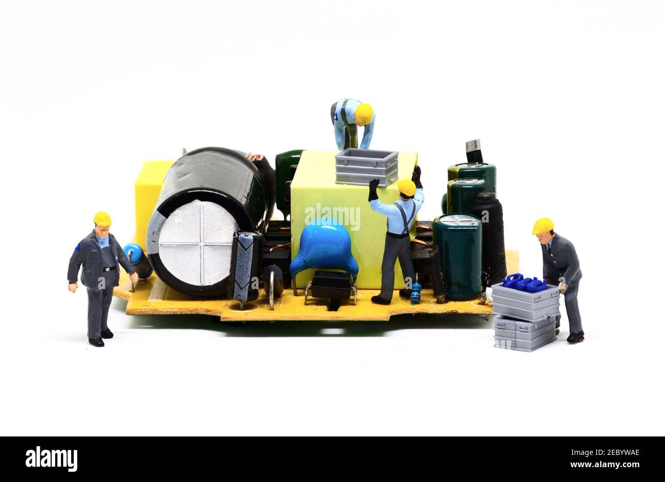 Workers repair computer charger. Miniature worker figurine and micro ...