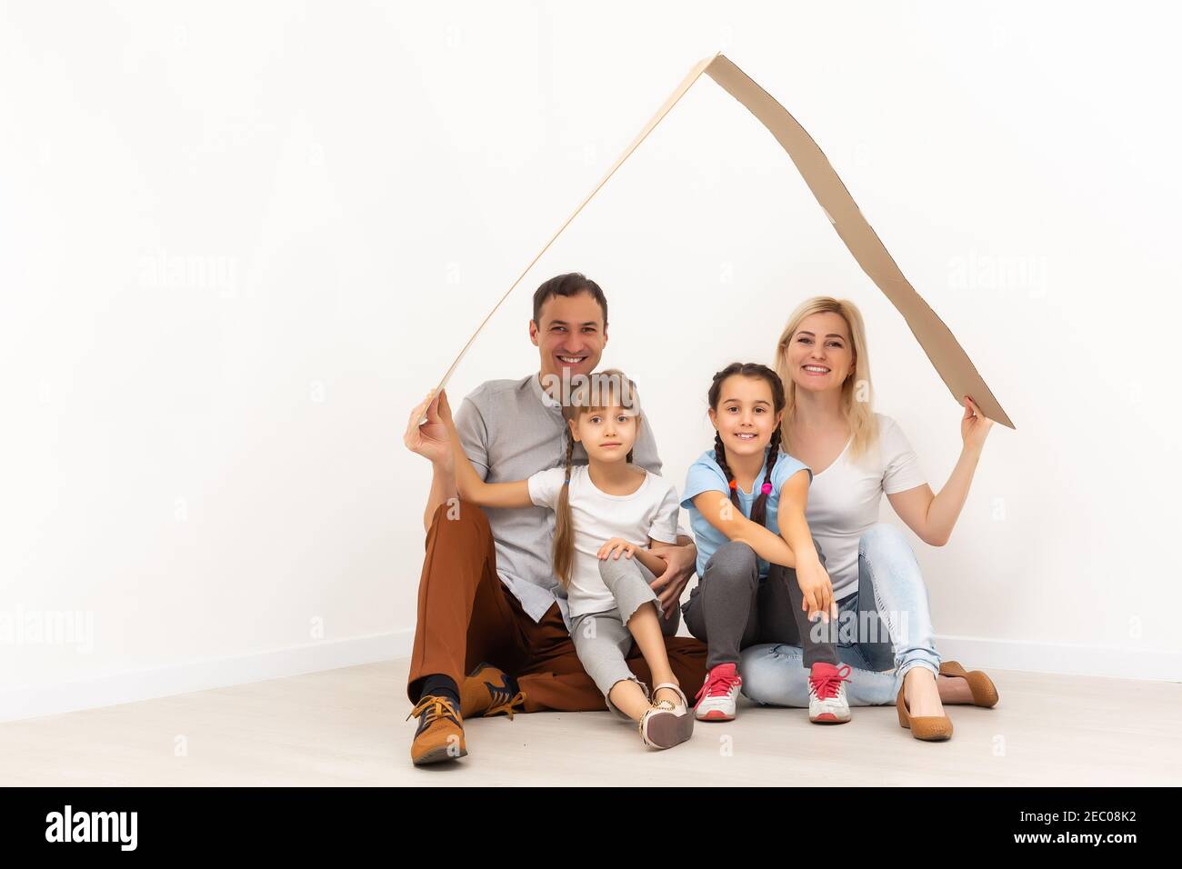 concept housing a young family. Mother father and children in new house ...