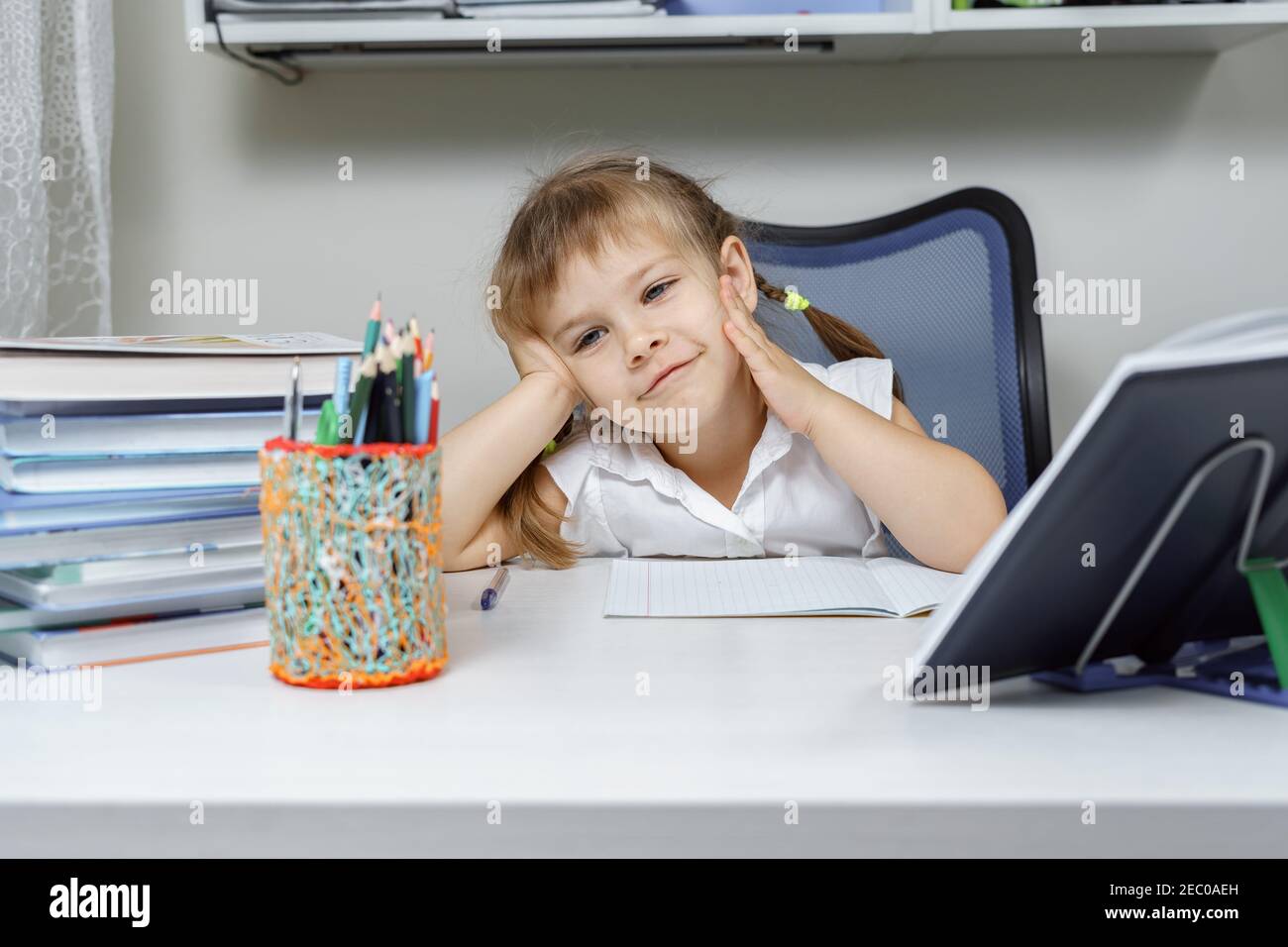 little girl doing homework at the table Stock Photo - Alamy