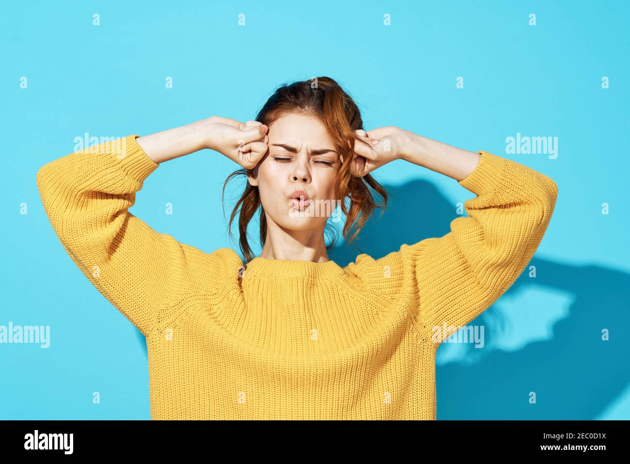 pretty woman in yellow sweater attractive look emotions close-up blue ...