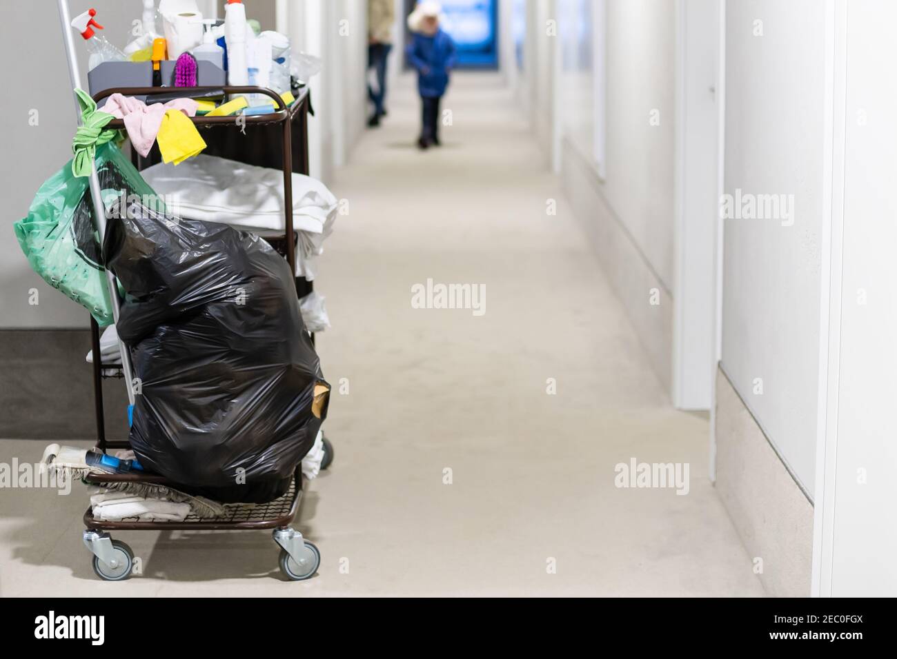 Cleaning utility janitorial cart in hotel corridor Stock Photo - Alamy