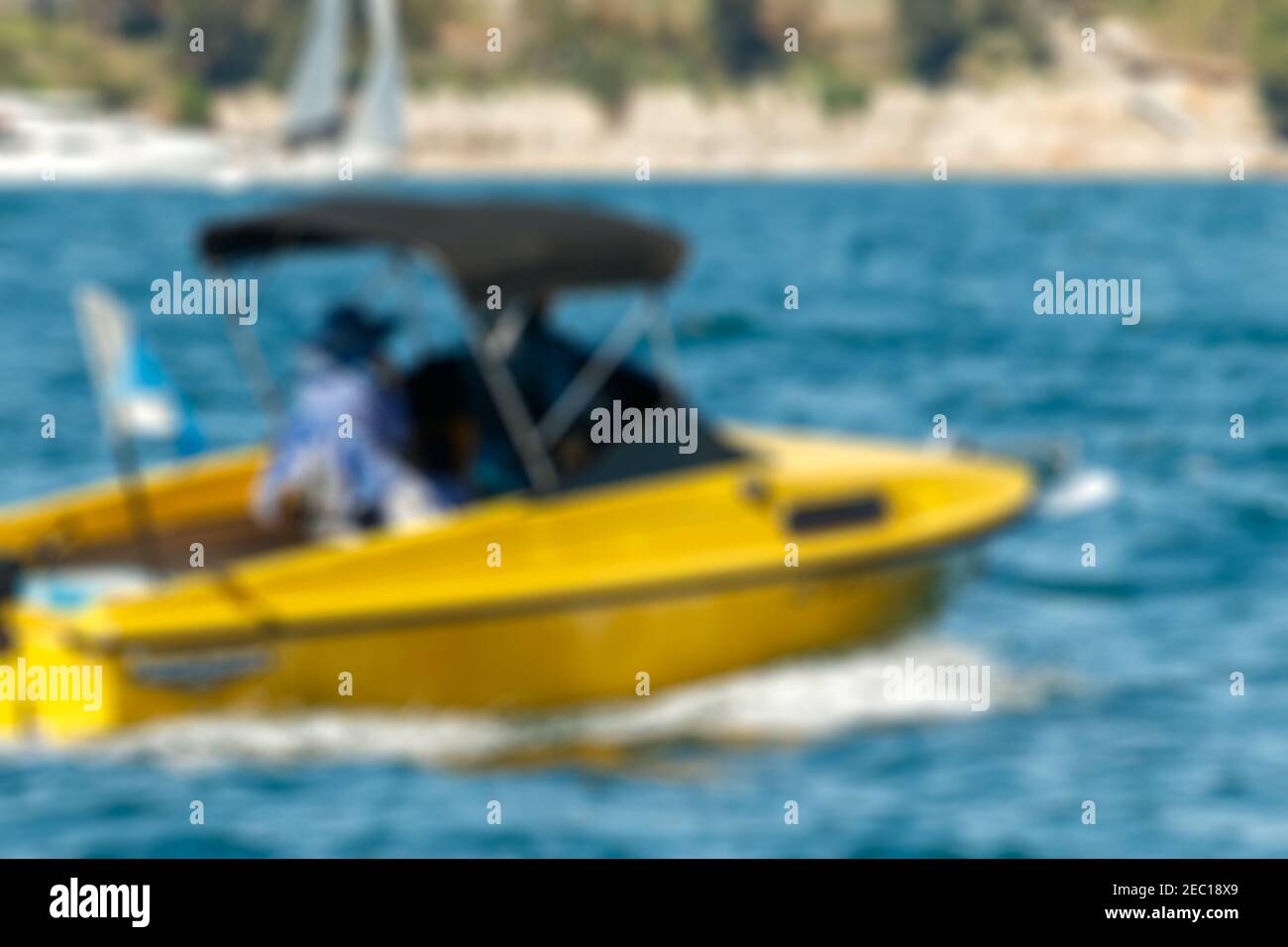 Abstract blurred image of a small yellow speed boat, for use as ...
