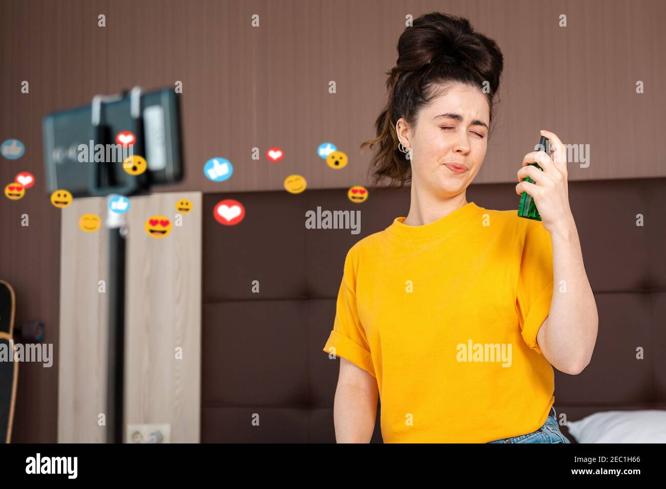 Portrait of young vlogger woman streaming live video on a smartphone ...