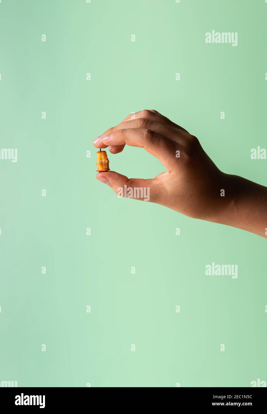 Hand of Caucasian boy with little haw stump in fingers. Fruit leftovers ...