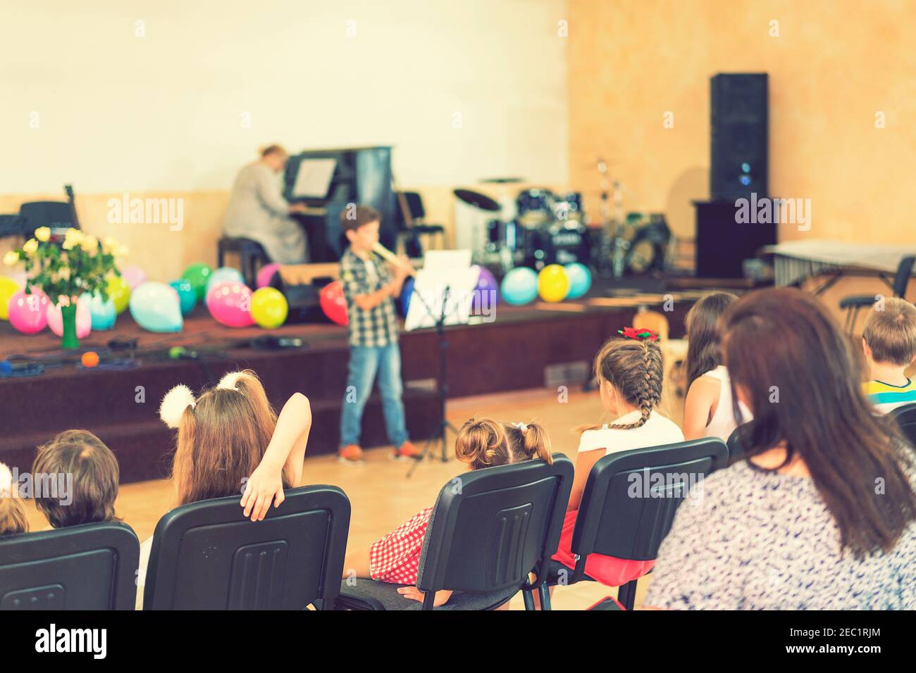 Children's holiday in elementary School. Children on stage perform in ...
