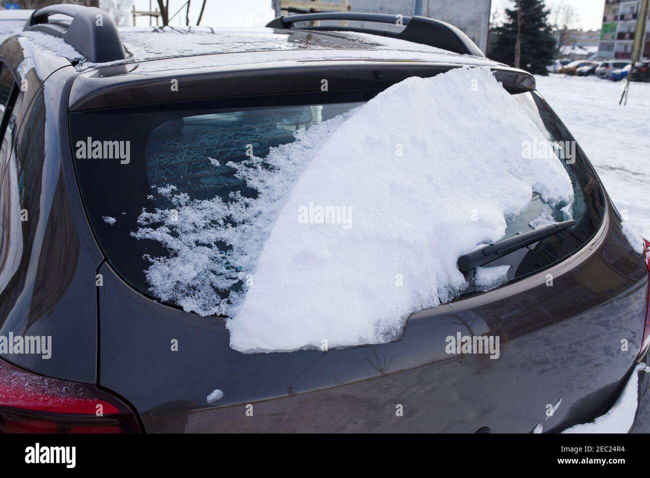 Frosted car covered with snow in the parking lot. Winter in Poland ...