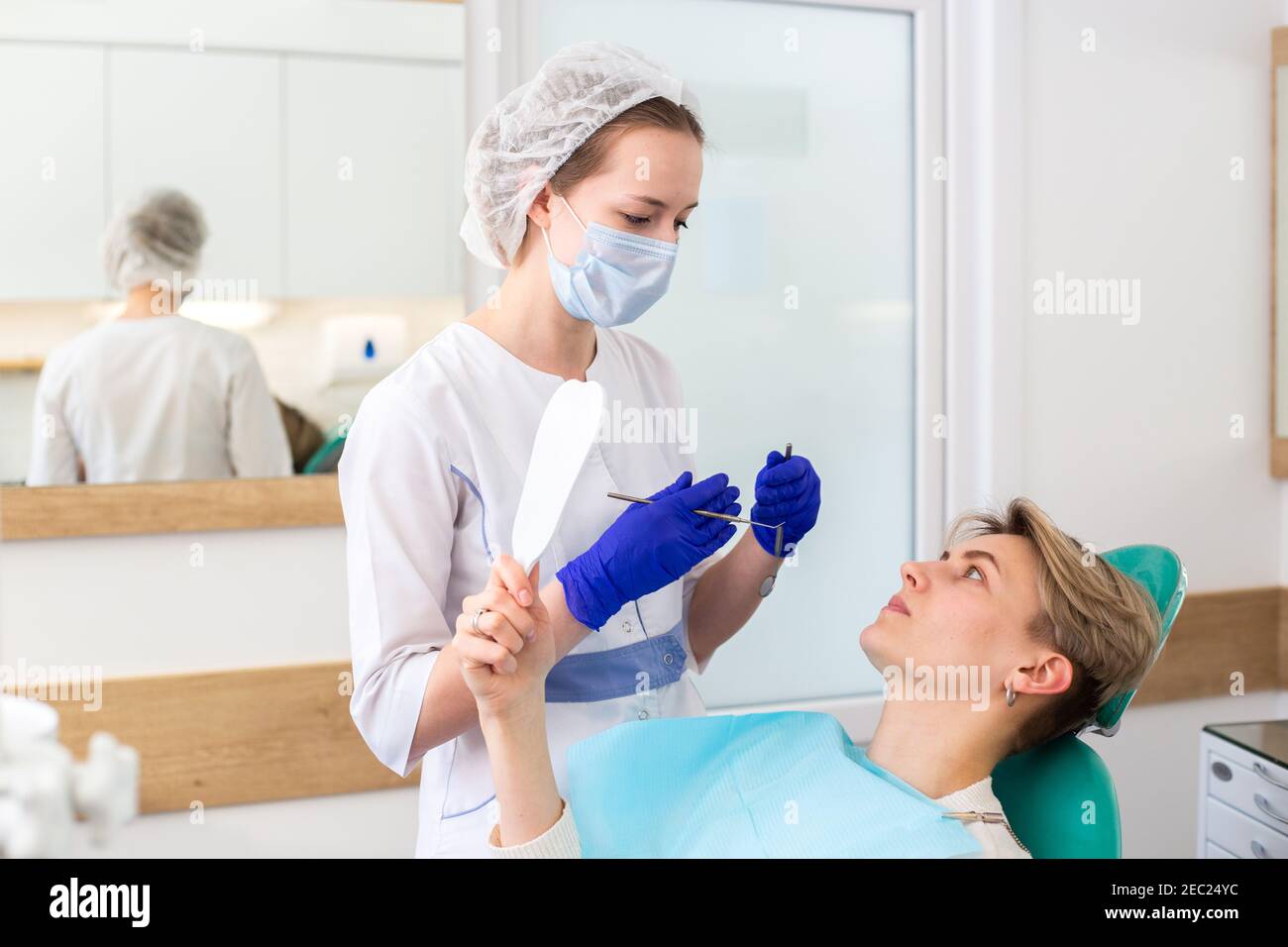 Young woman at the dentist consultation. Checking and dental treatment ...