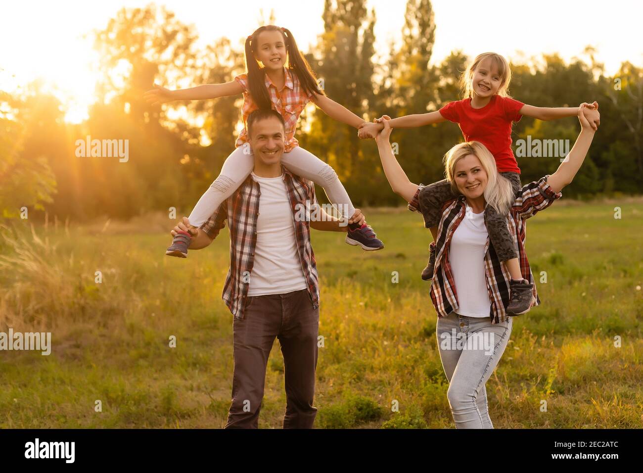 Happy family on sunset in nature Stock Photo - Alamy