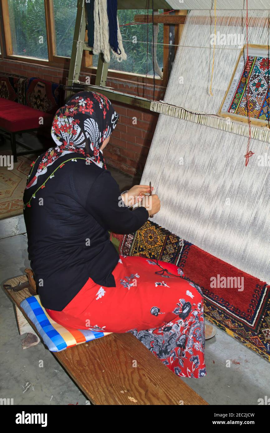 Turkish woman knotting a carpet. Using a double knot that is unique to ...