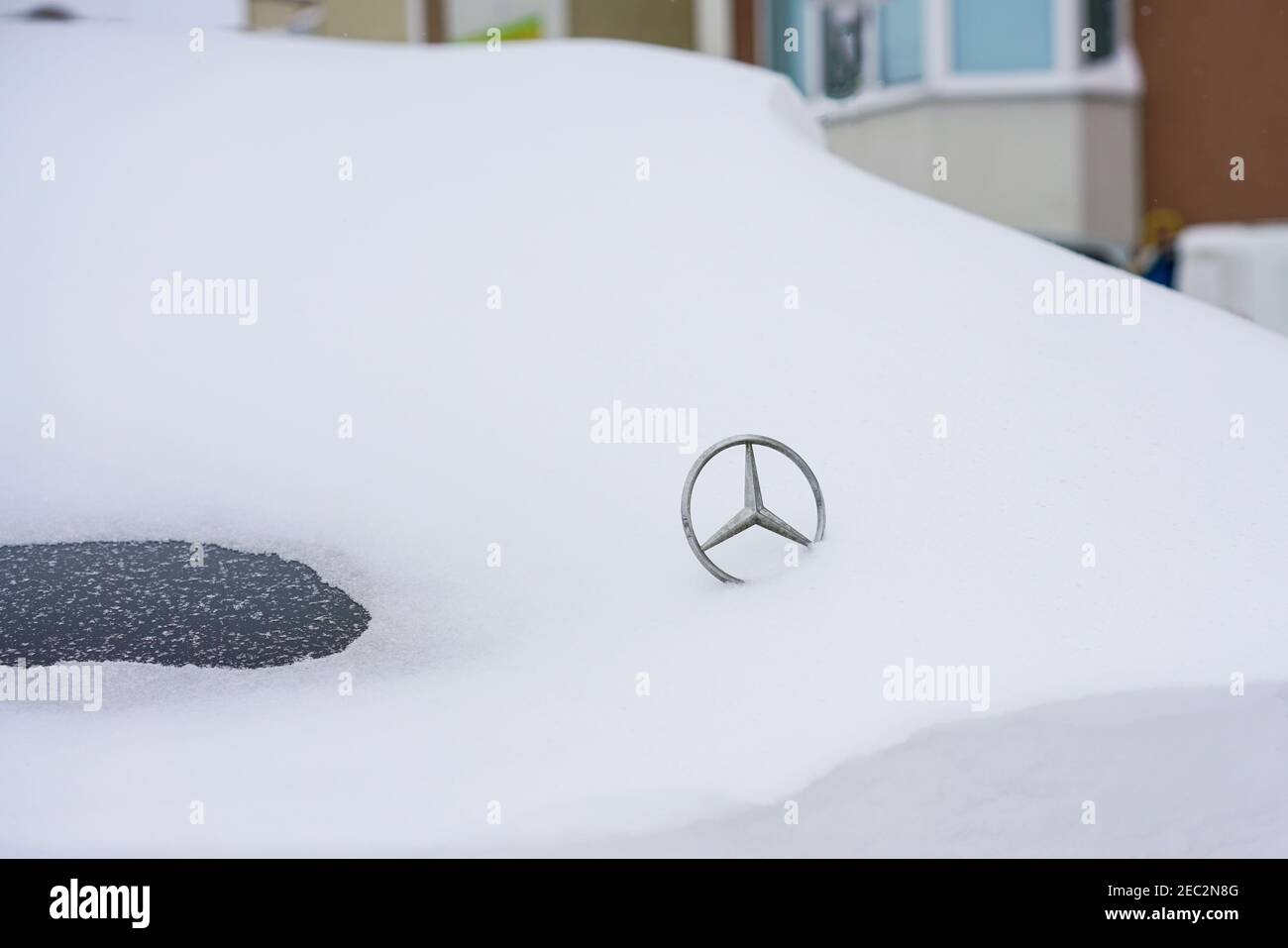 Snow-covered car with Mercedes icon visible, January 13, 2021 Kiev ...