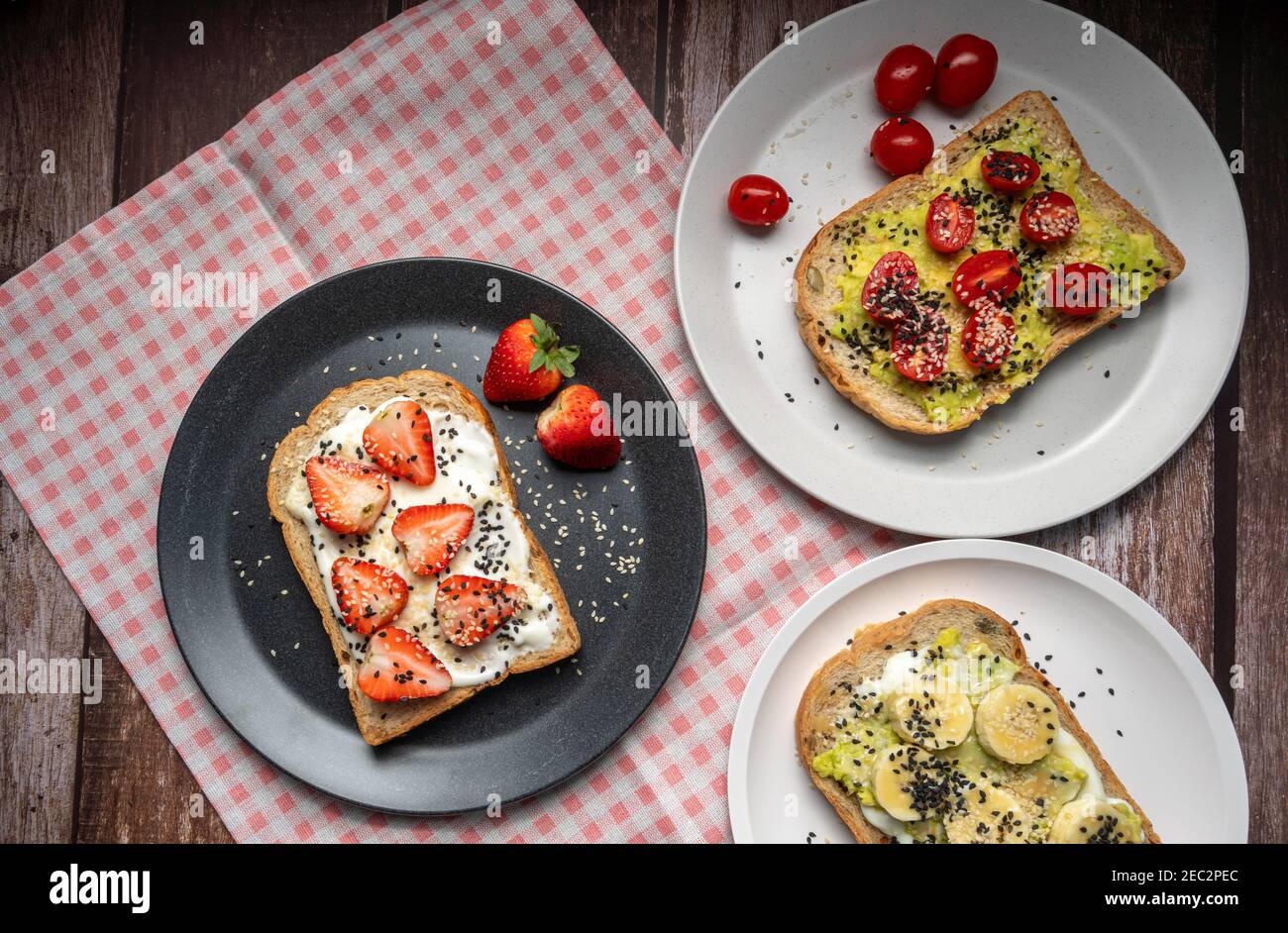 Healthy breakfast toasts with Avocado toast, tomato, strawberry ...
