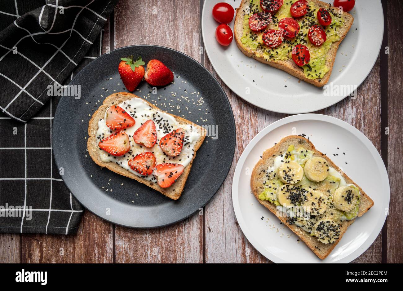 Healthy breakfast toasts with Avocado toast, tomato, strawberry ...