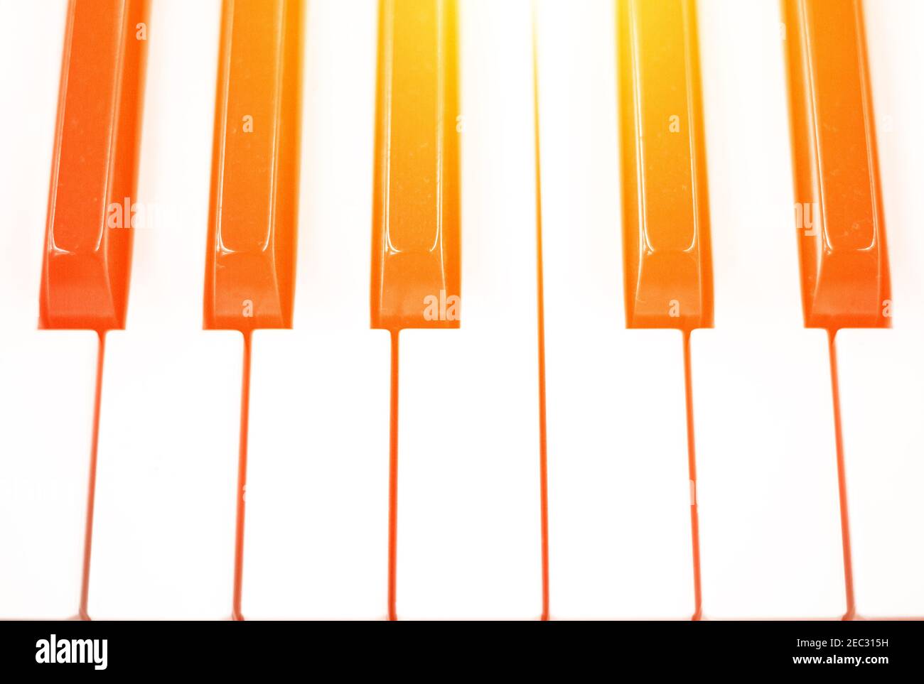 Piano keys in yellow light toned photo. Black and white keyboard of ...