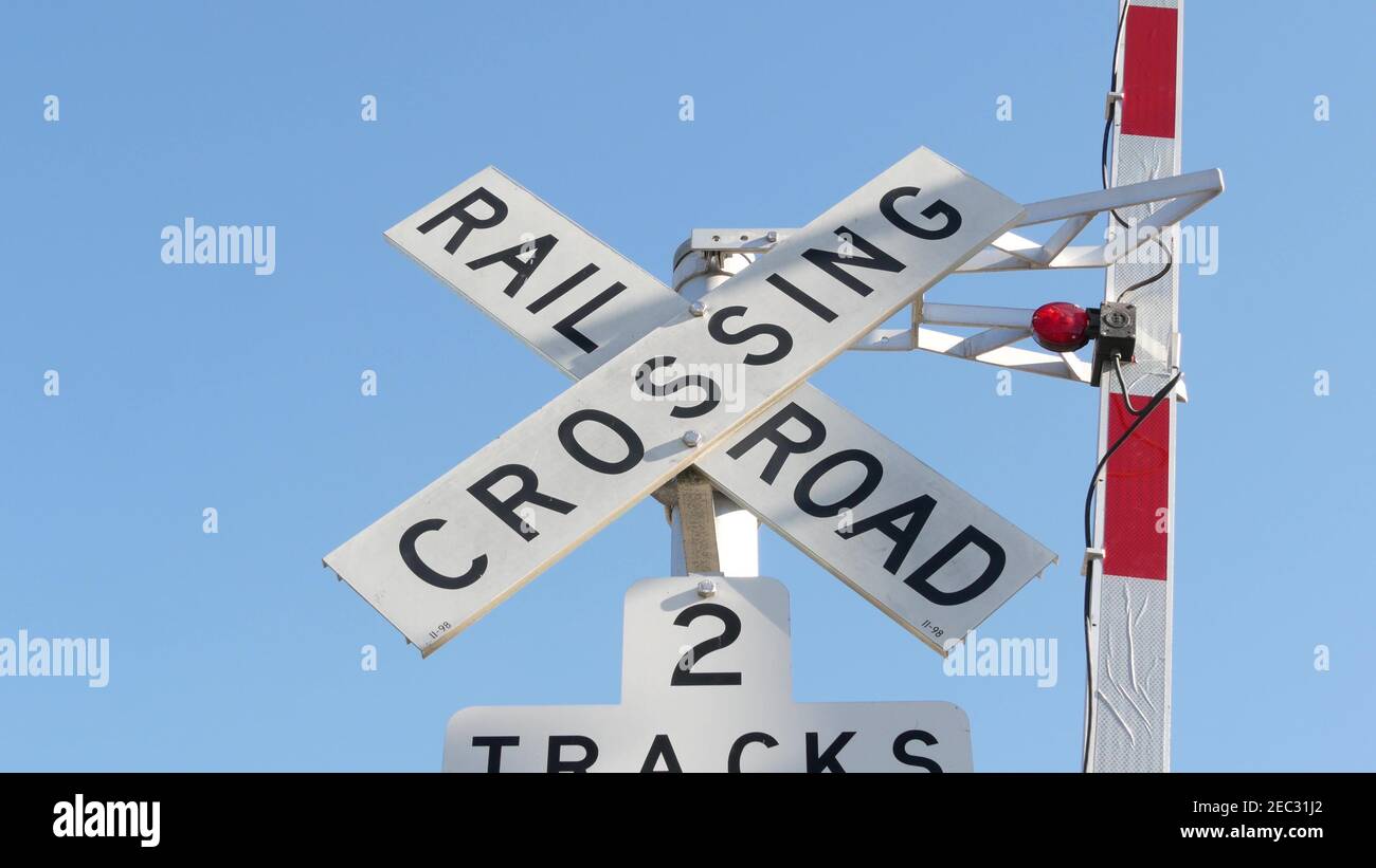 Level crossing warning signal in USA. Crossbuck notice and red traffic ...