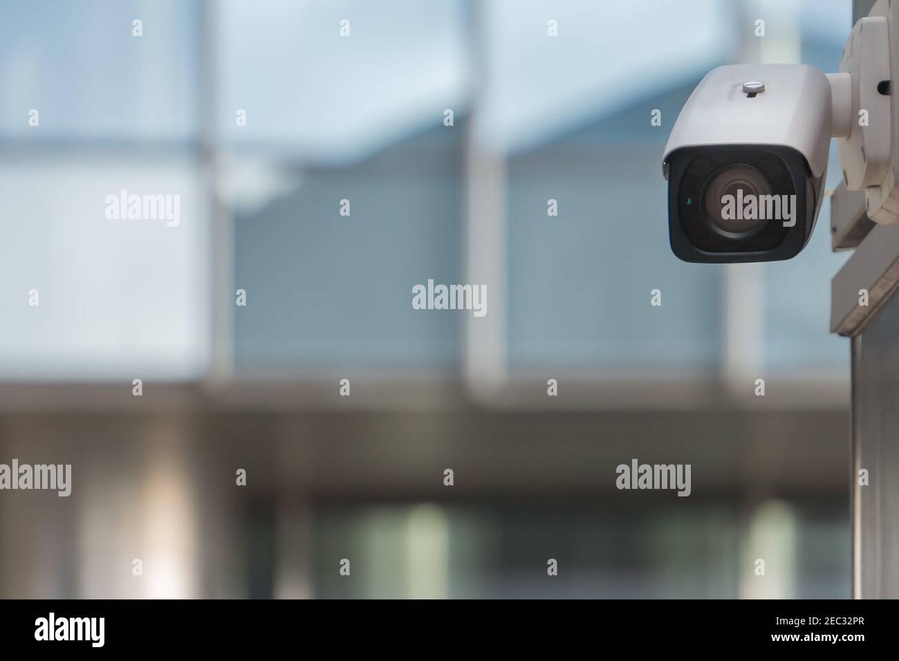 Modern CCTV security camera installed on building wall in city. Concept ...