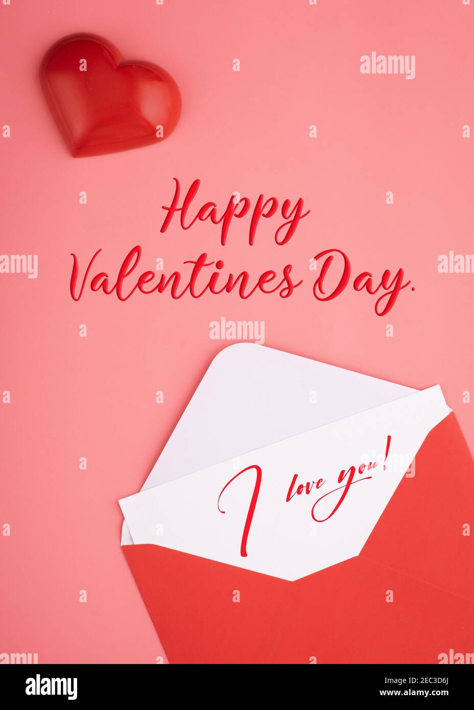 open envelope with card, heart and rose petals on pink background with ...
