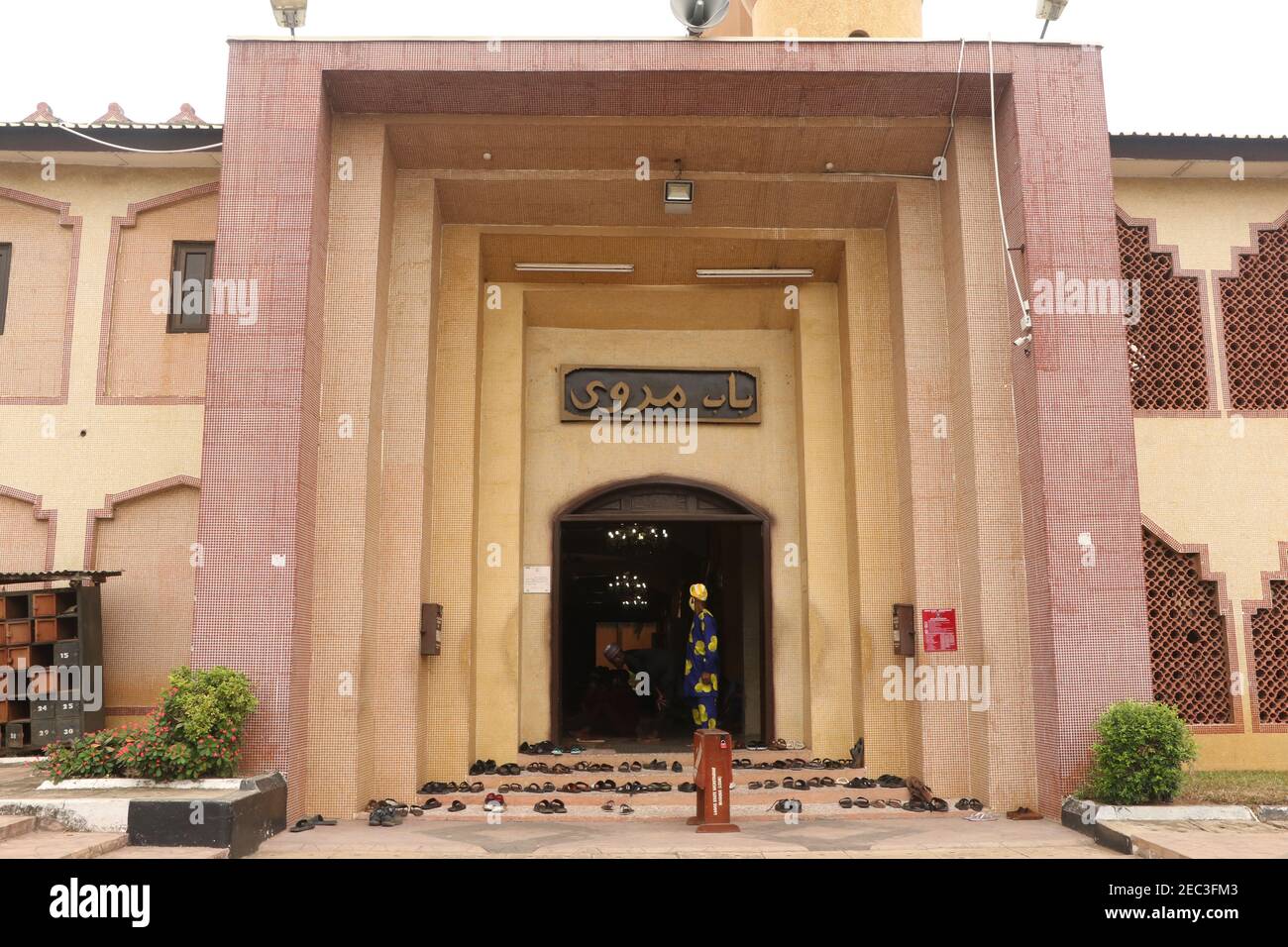 A Muslim faithful stand guard at the entrance of the Lagos central ...