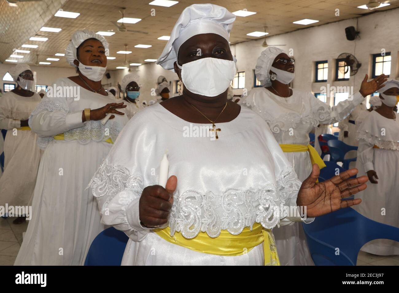 Christian faithful wearing face mask and maintaining social distancing ...