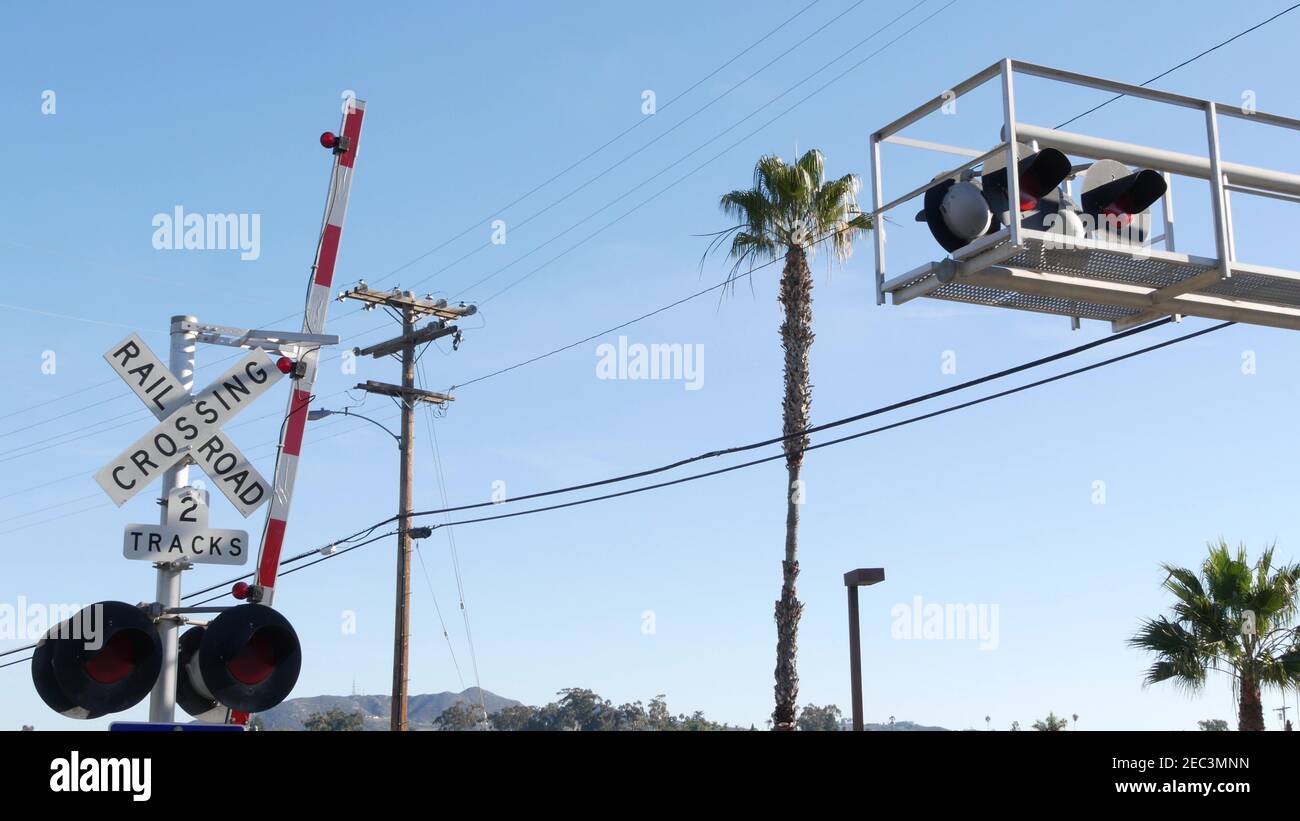 Level crossing warning signal in USA. Crossbuck notice and red traffic ...