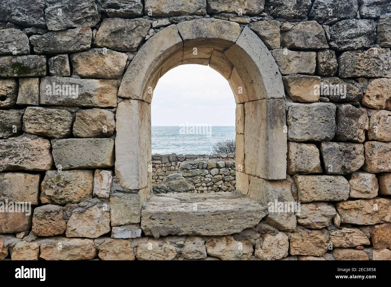 semicircular window opening in the ruins of an antique wall, behind ...