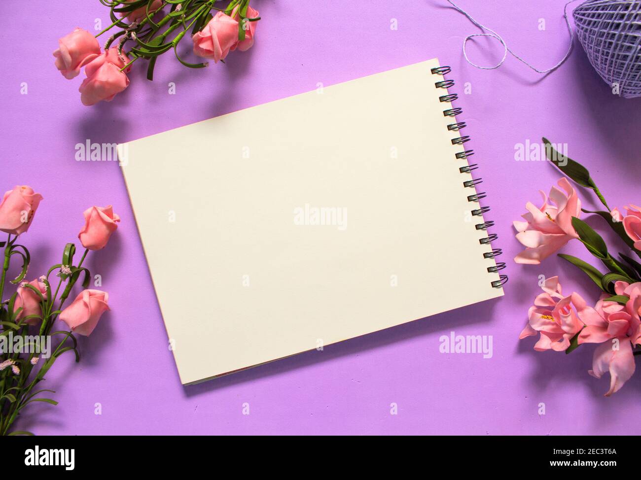 Romantic roses flat lay with blank page notebook on violet background ...