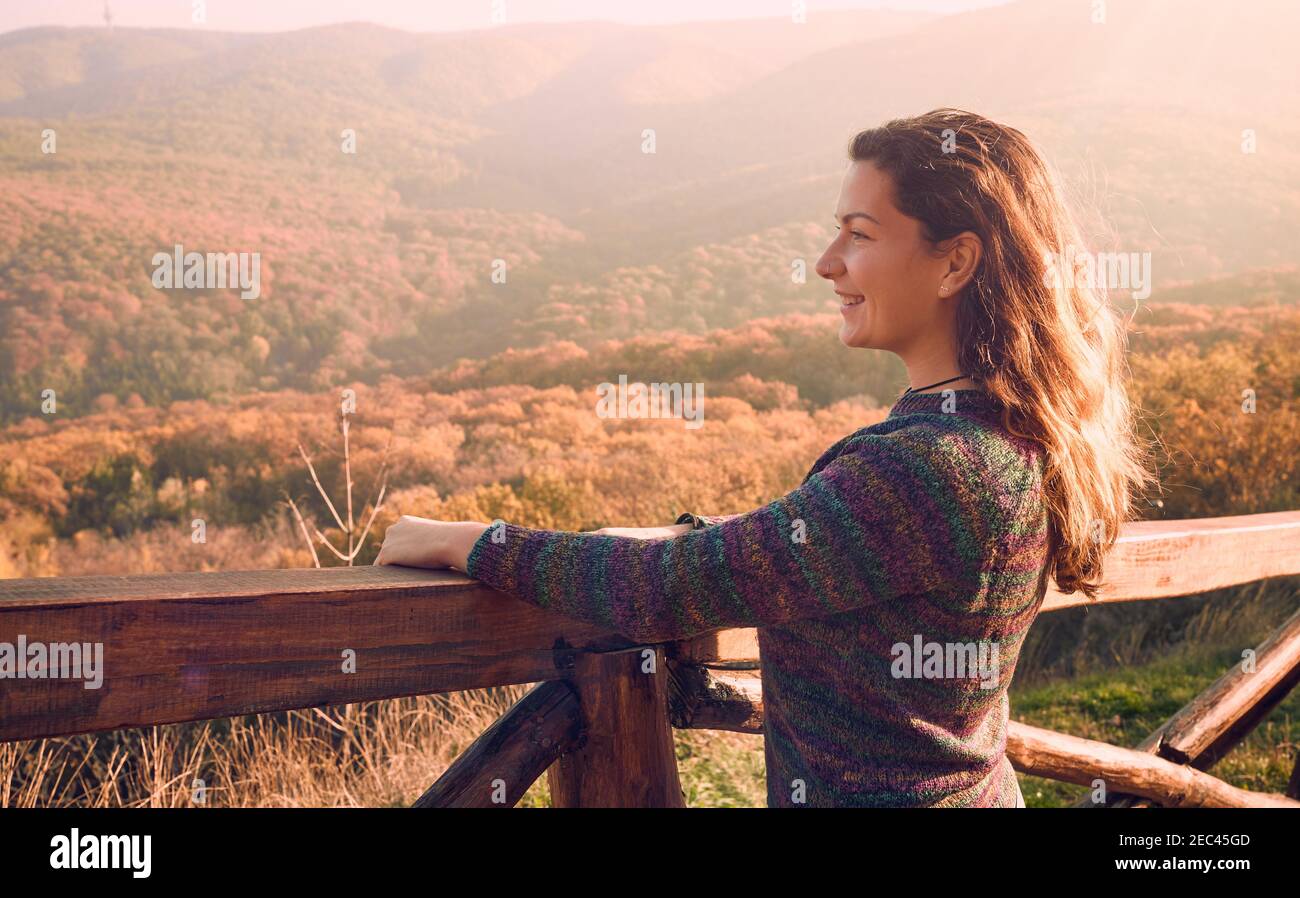 smiling young woman enjoy the moment of happiness in nature feeling ...