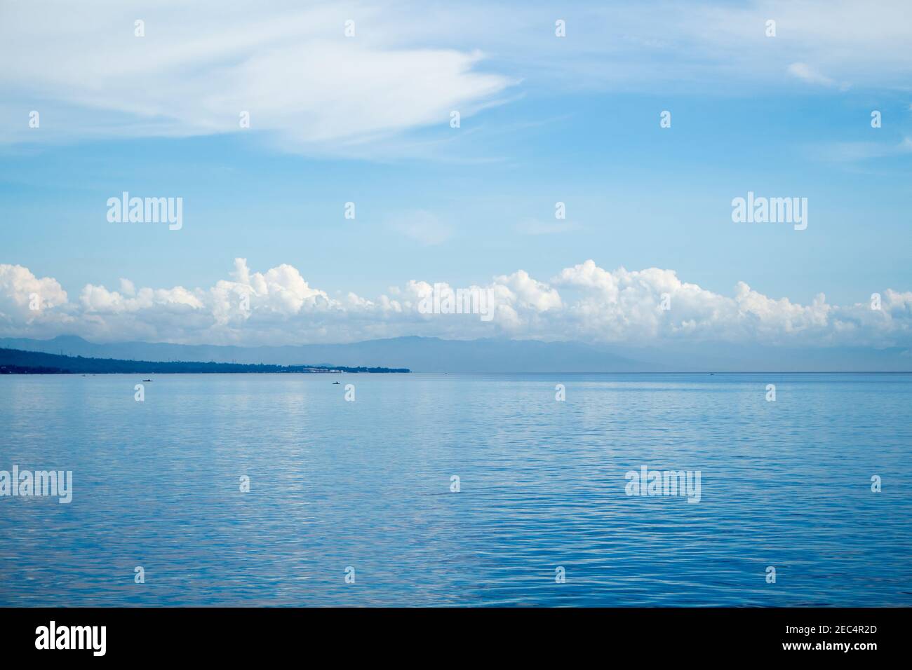 Tropical seascape with distant island and blue sky. Relaxing sea view ...